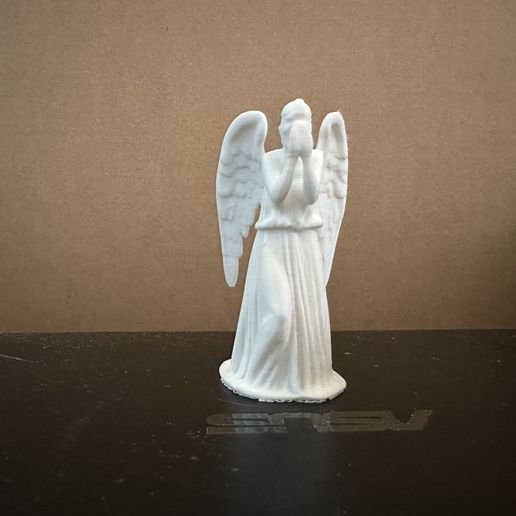 crying cherub statue